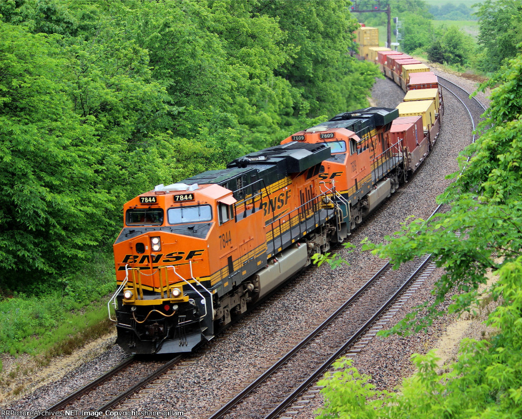 BNSF 7844 leads a wb stack train around the s turns.